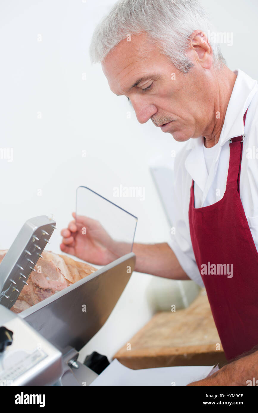 Butcher slicing meat Stock Photo - Alamy