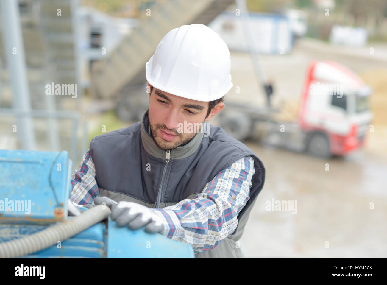 Man with compressor on construction site Stock Photo - Alamy