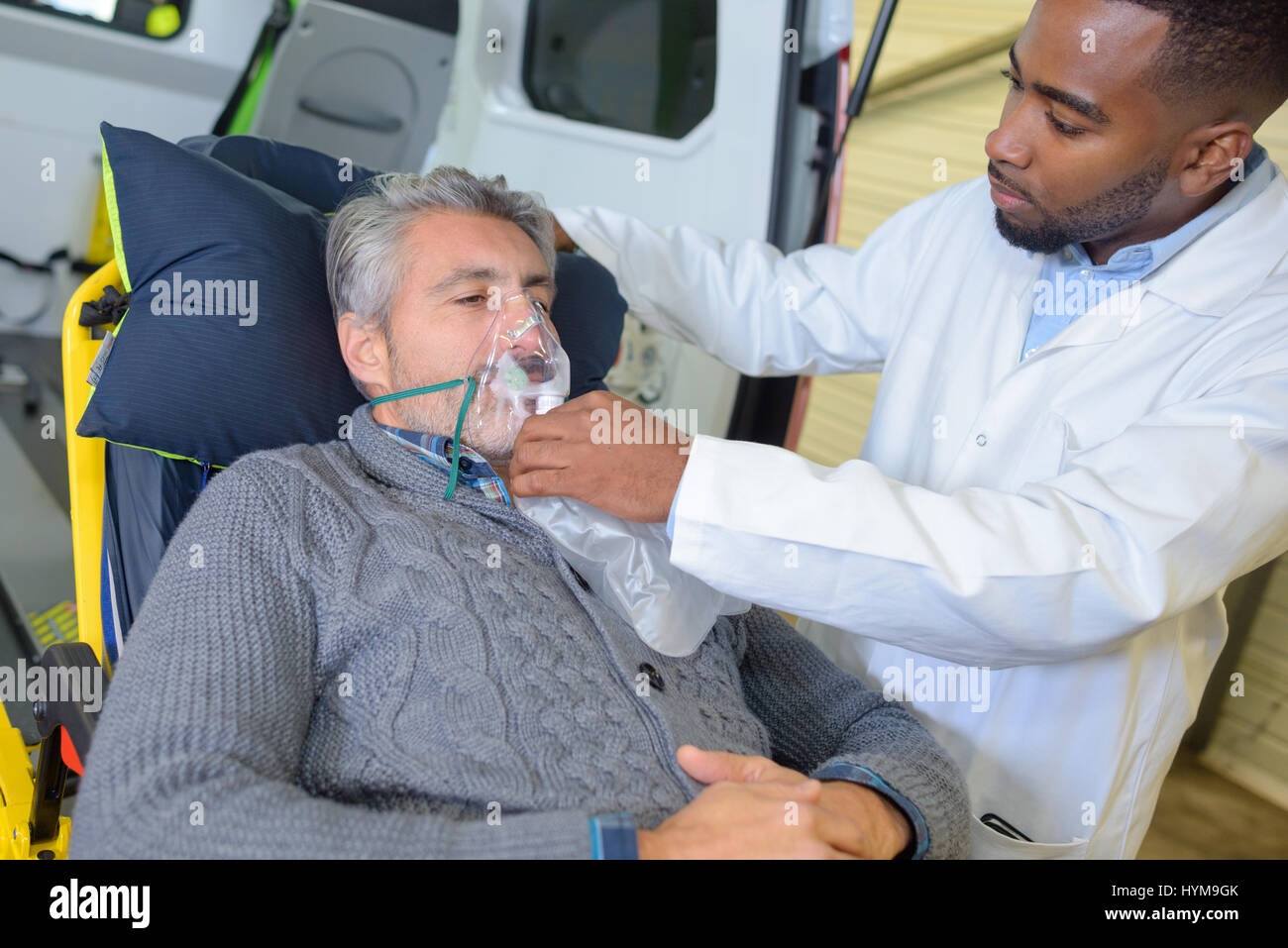 Paramedic giving oxygen to patient Stock Photo - Alamy Paramedic giving oxygen to patient Stock Photo - Alamy