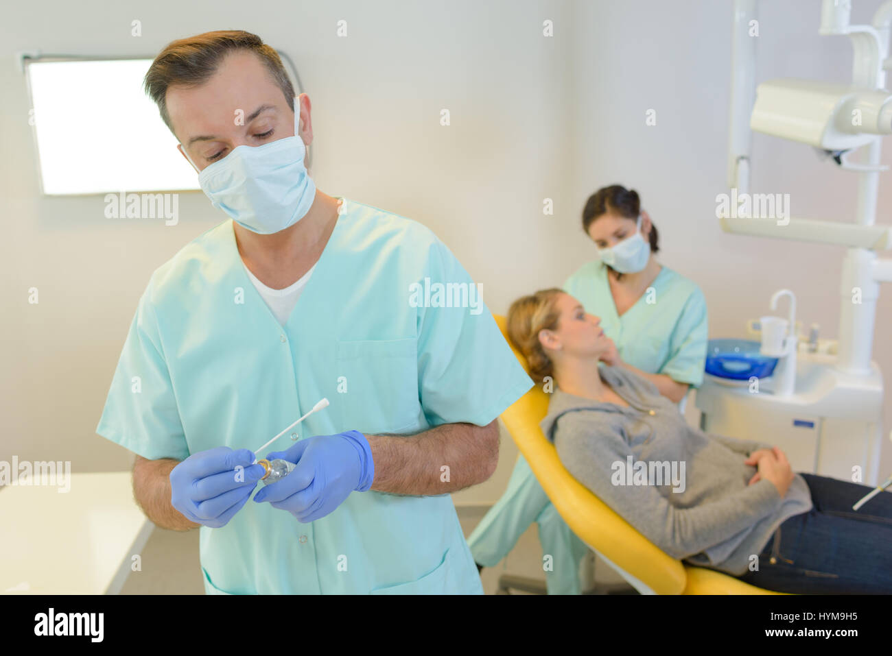 dentist curing a woman patient in the dental office Stock Photo - Alamy