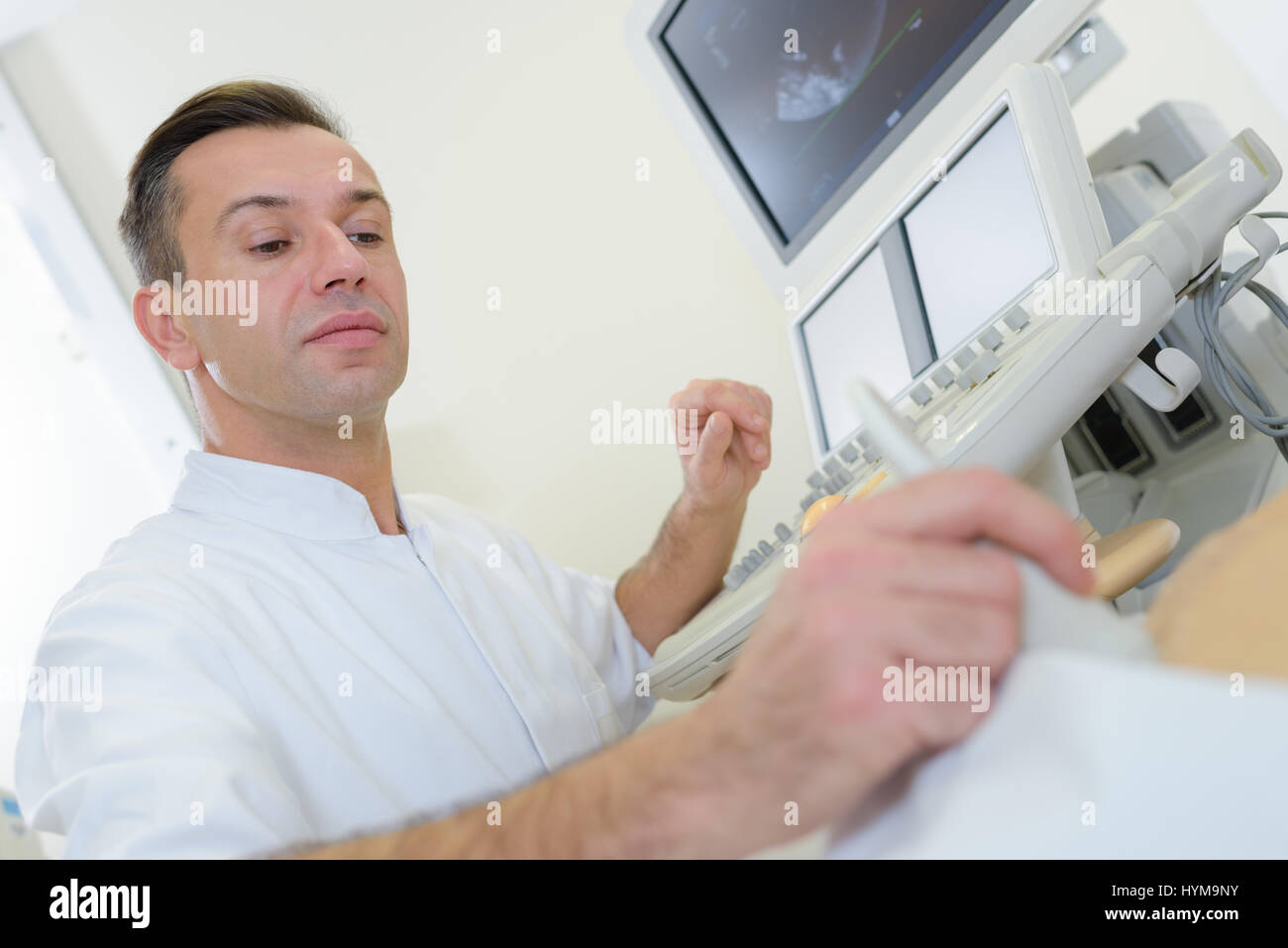 Doctor performing ultrasound Stock Photo - Alamy