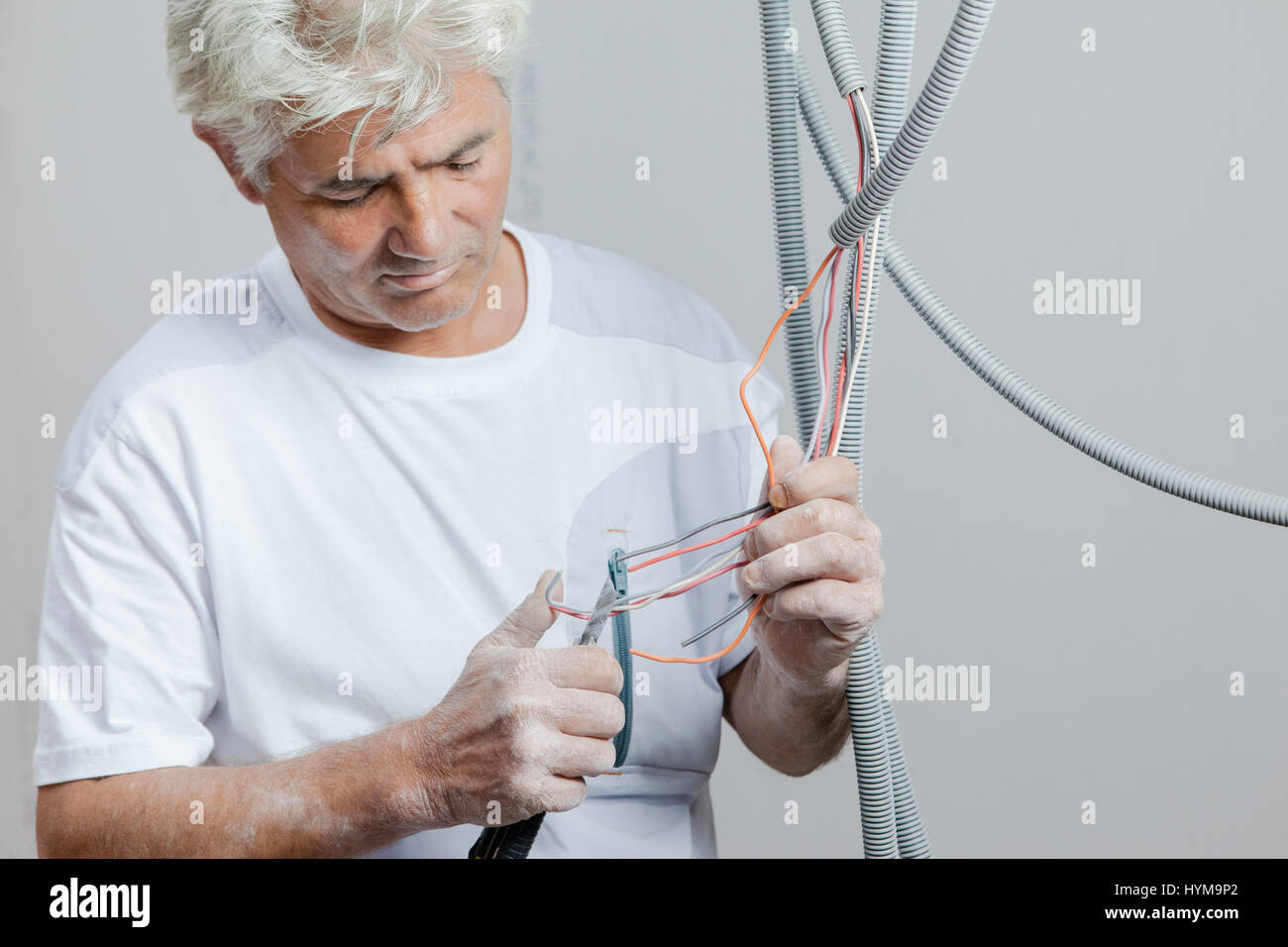 Electrician clipping electrical wires Stock Photo - Alamy