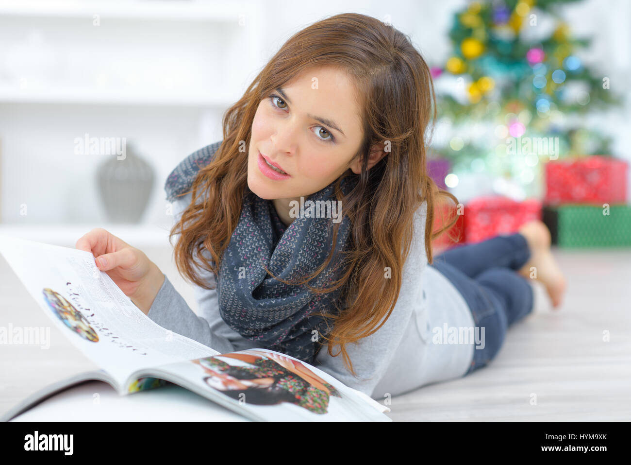Woman reading a magazine on the floor Stock Photo - Alamy