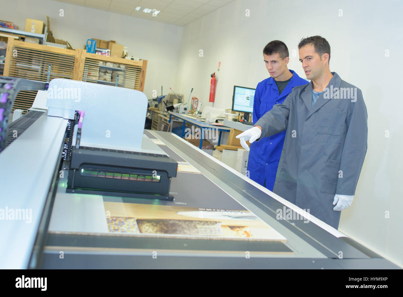 Two men in printing shop Stock Photo - Alamy