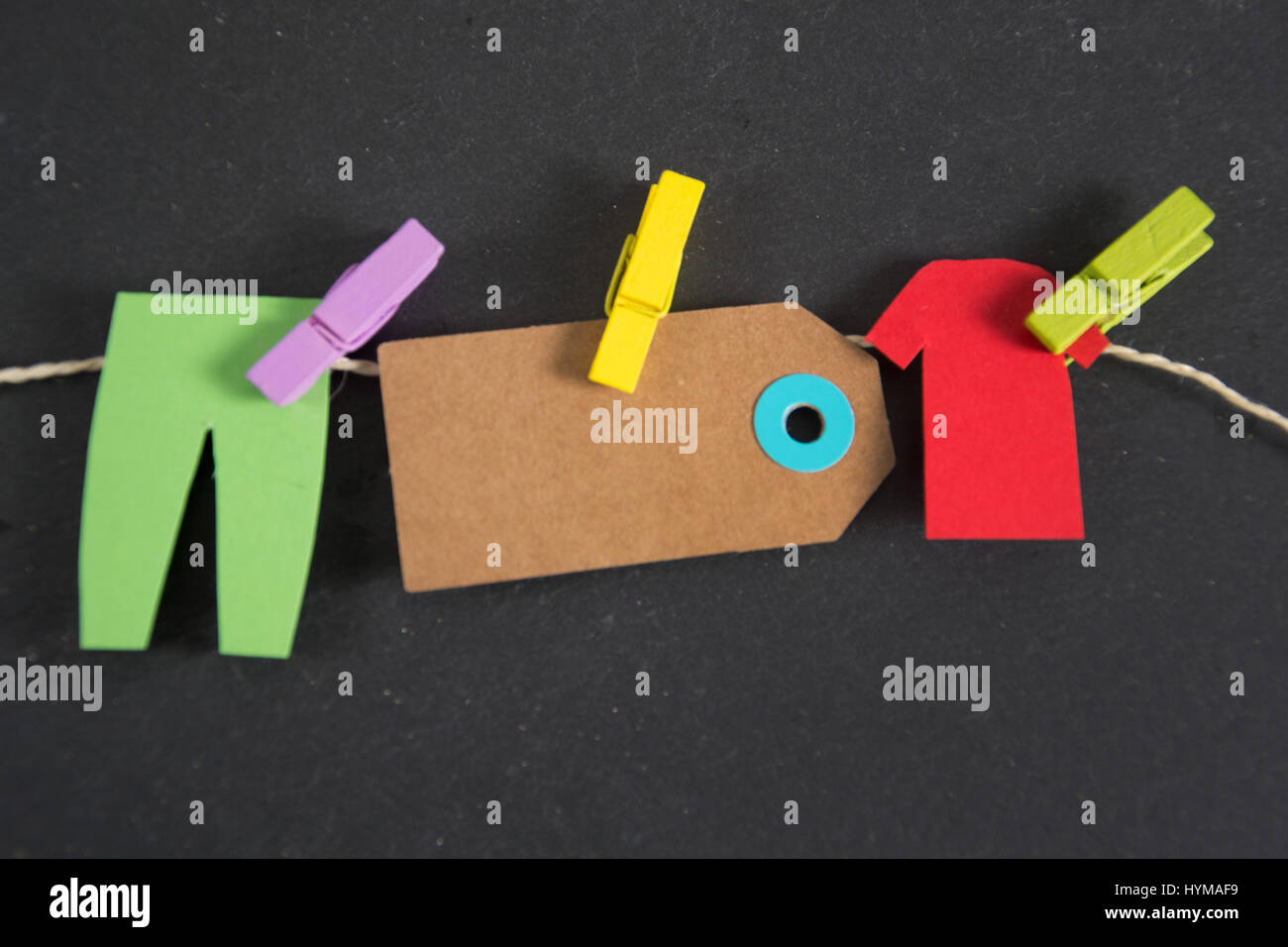 paper clothes with a paper tag Stock Photo - Alamy