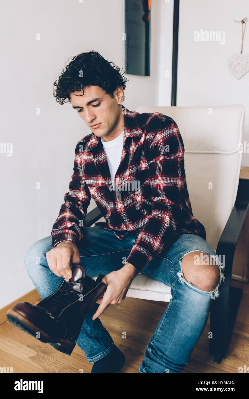 Handsome young man wearing shoes indoor - casual clothing, everyday ...