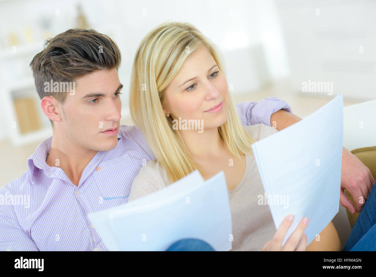 Couple reading through an important document Stock Photo - Alamy
