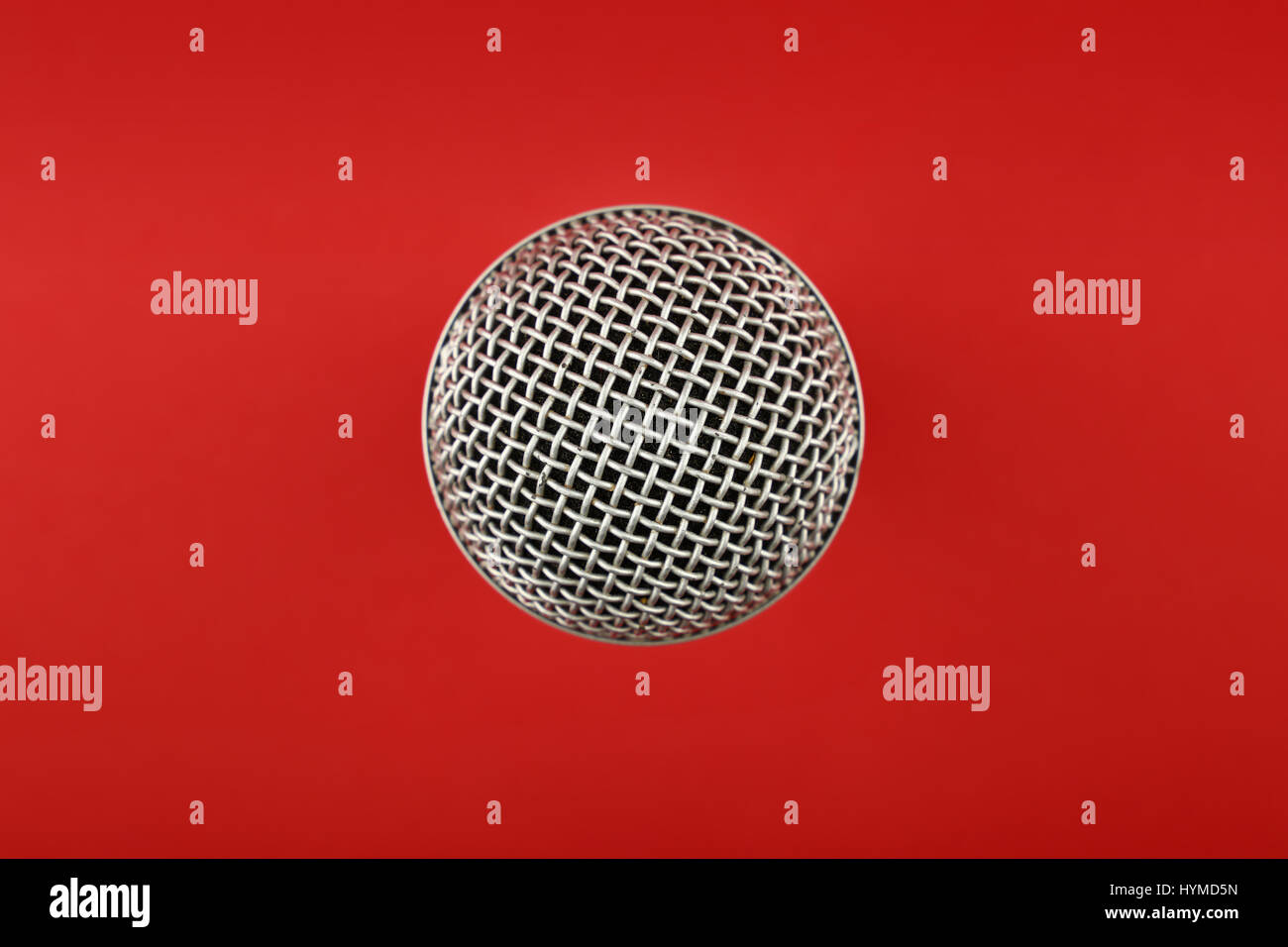 Microphone top view over red background, close up, personal perspective ...