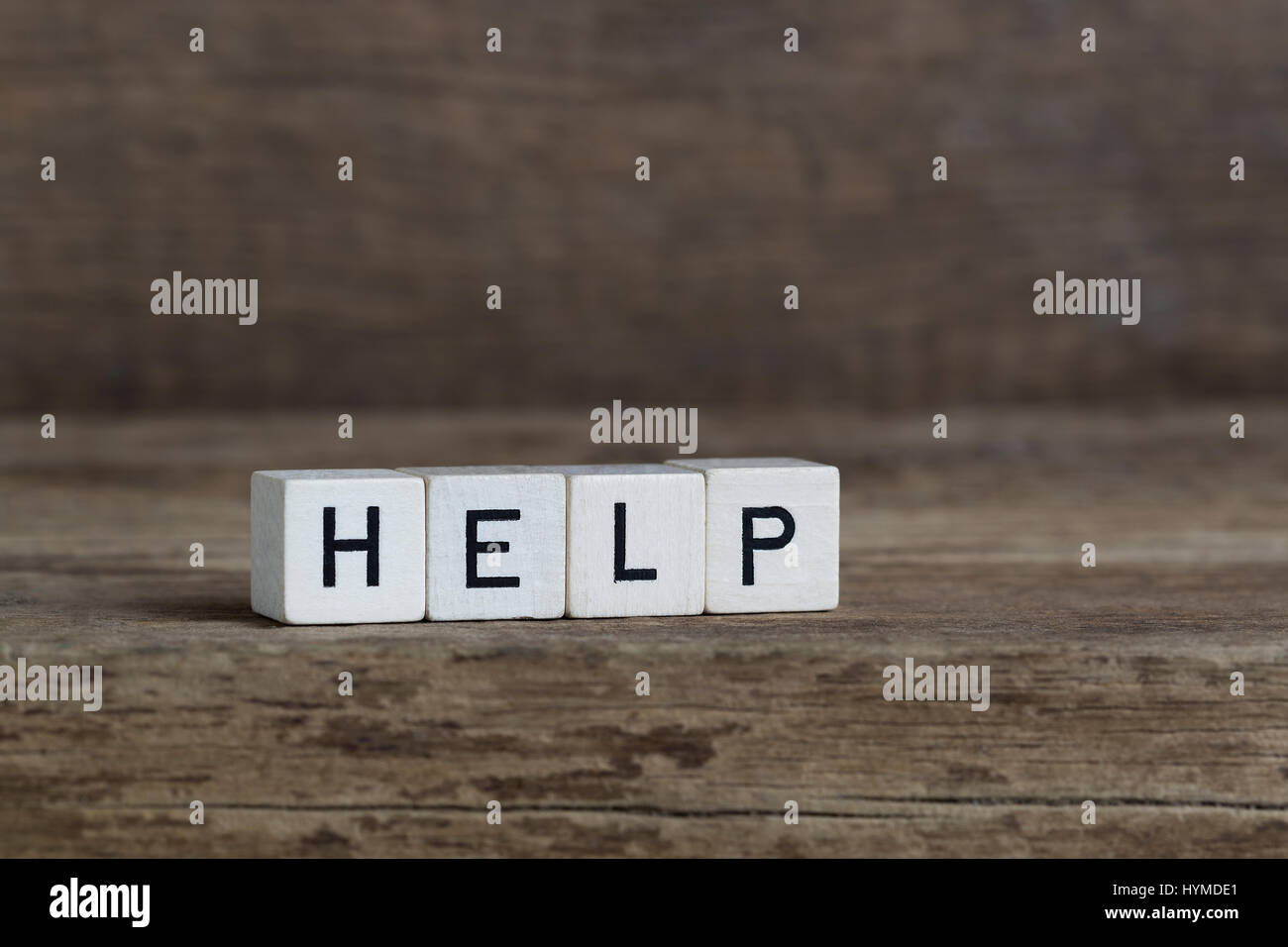 Help, written in cubes on a wooden background Stock Photo - Alamy