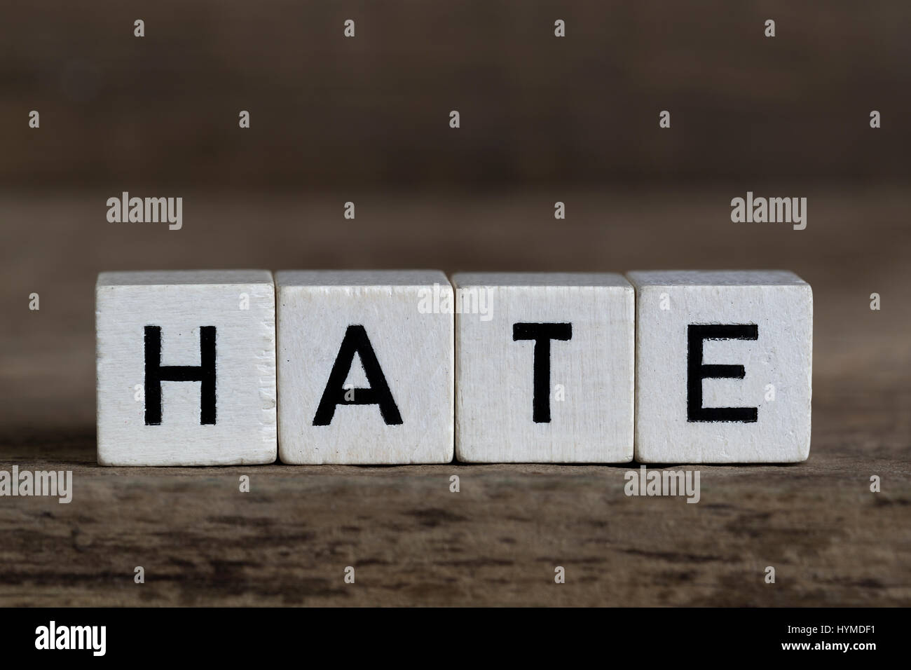 Hate, written in cubes on a wooden background Stock Photo - Alamy
