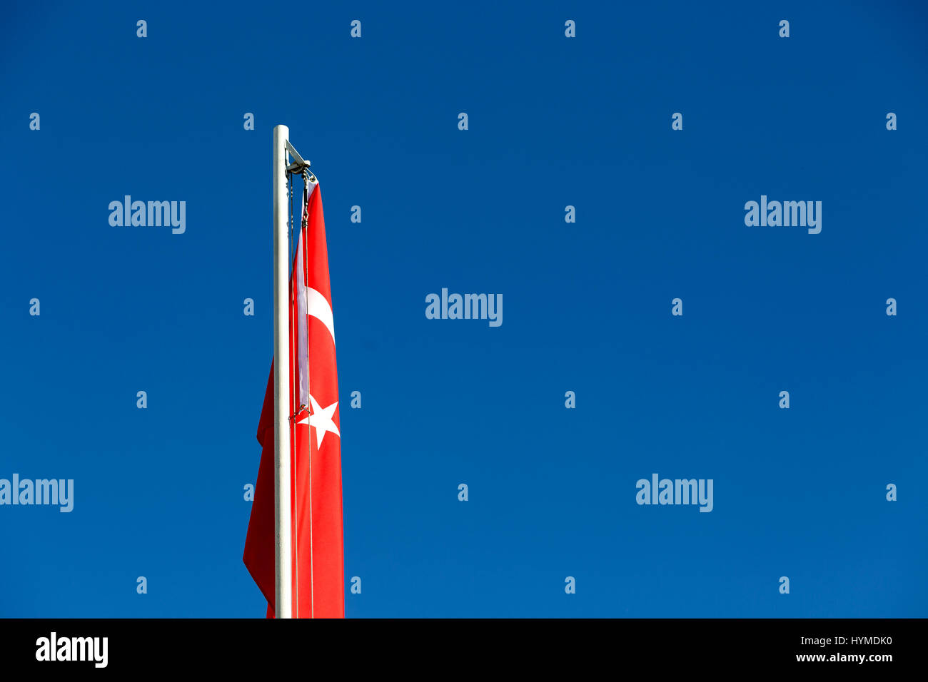 National flag of Turkey on a flagpole in front of blue sky Stock Photo ...