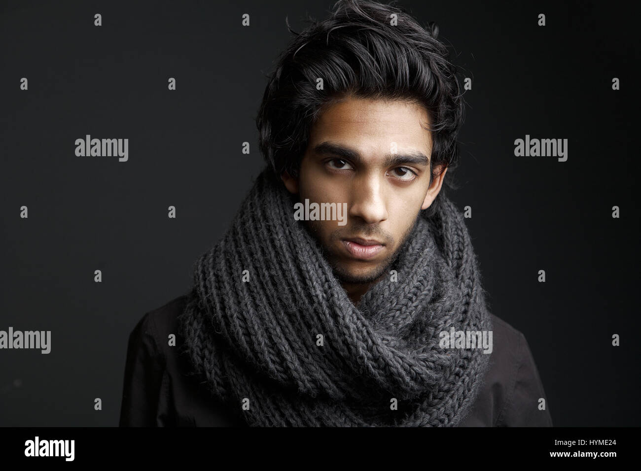 Close up horizontal portrait of a handsome young man with wool scarf ...
