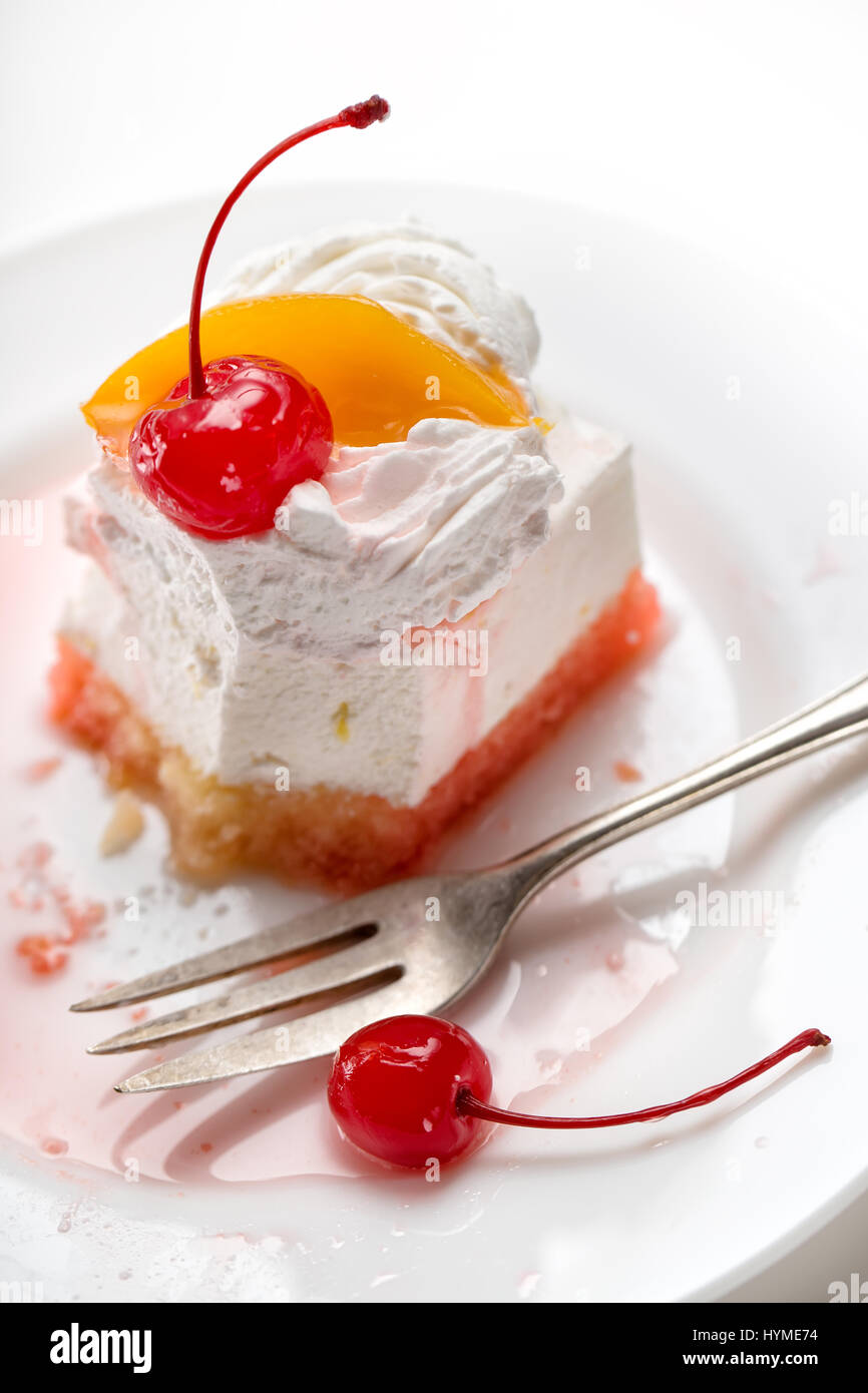 Fragment of bitten cake with dessert fork isolated on white background ...