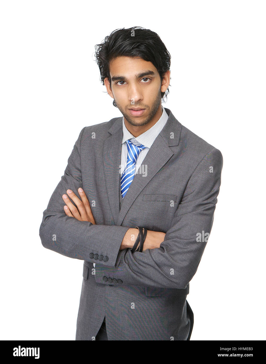 Close up portrait of a young business man standing with arms crossed ...