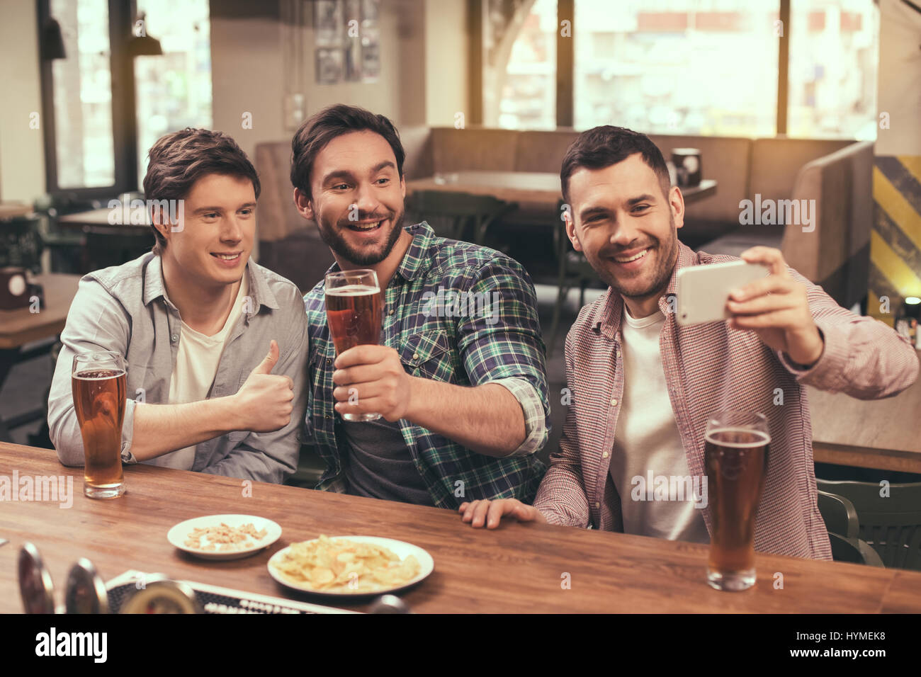 Friends having fun in pub Stock Photo - Alamy