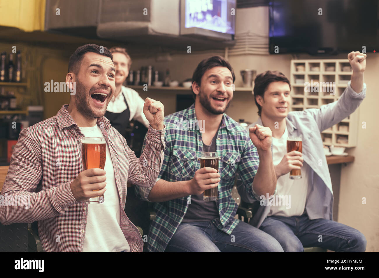 Friends having fun in pub Stock Photo - Alamy