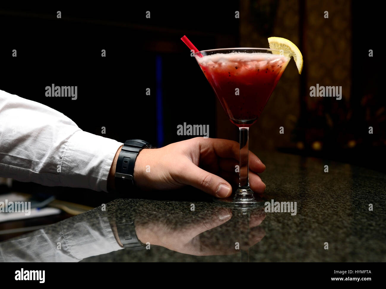 bartender serving cocktail at the counter in a bar Stock Photo - Alamy