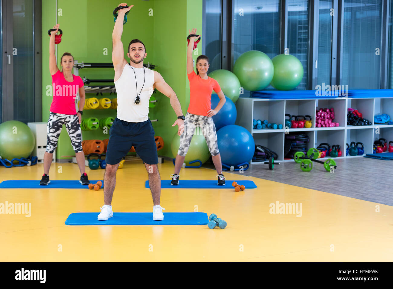 Kettlebells swing exercise man and woman workout at gym Stock Photo - Alamy