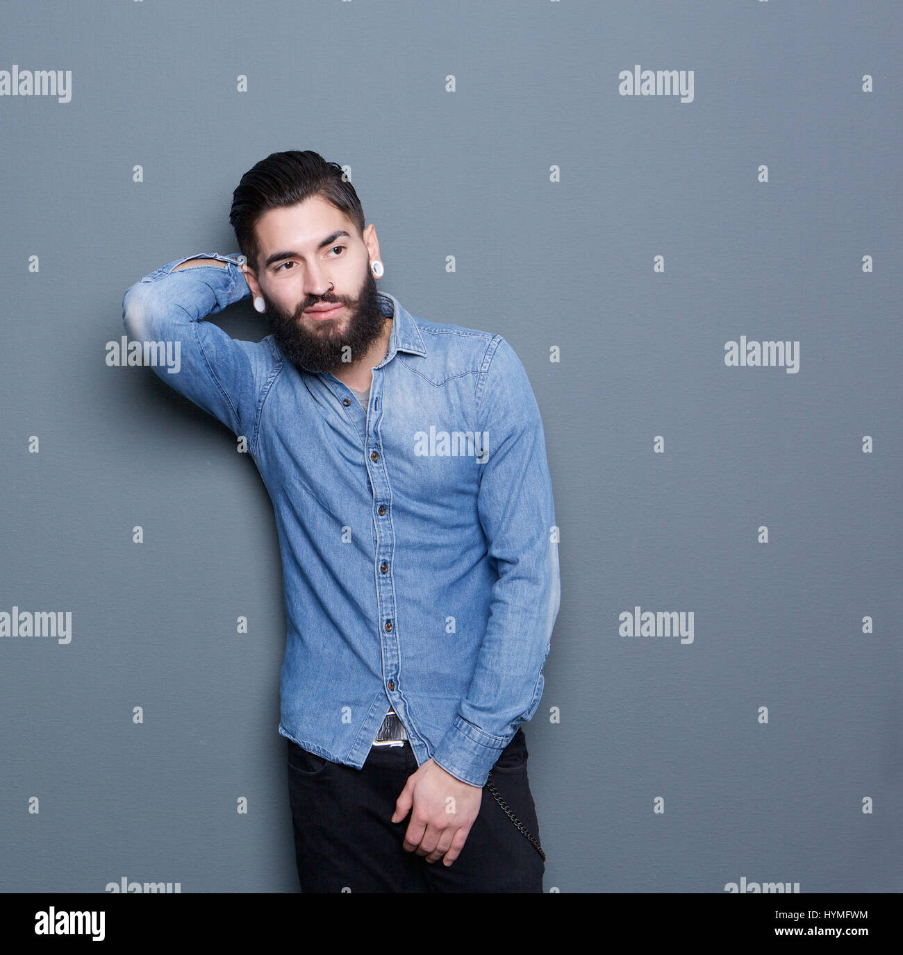 Portrait of a male fashion model posing on gray background Stock Photo ...