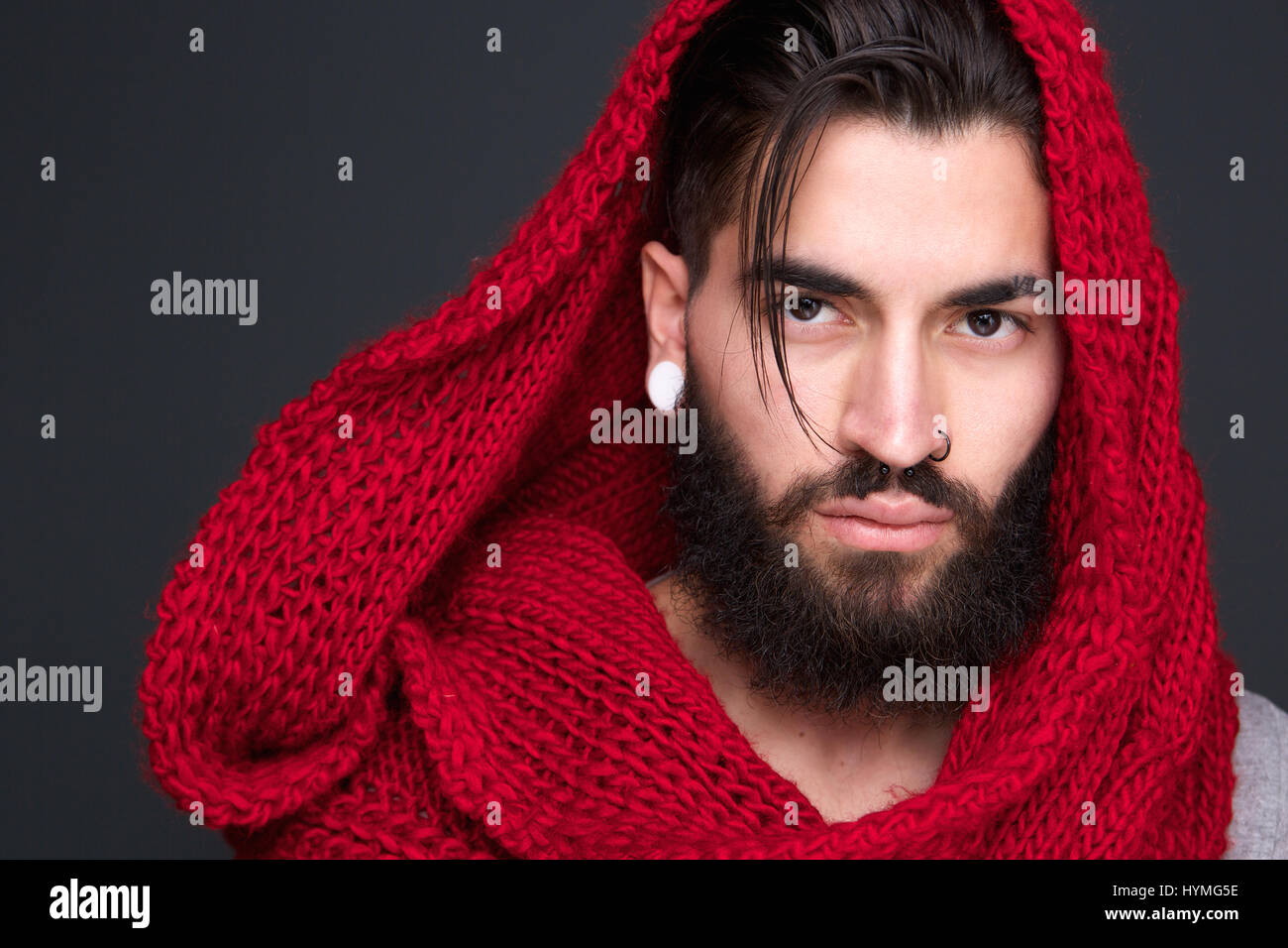 Close up portrait of a male fashion model posing with wool scarf on ...