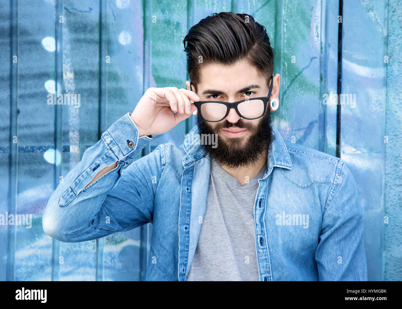 Horizontal portrait of a handsome modern man with beard and glasses ...