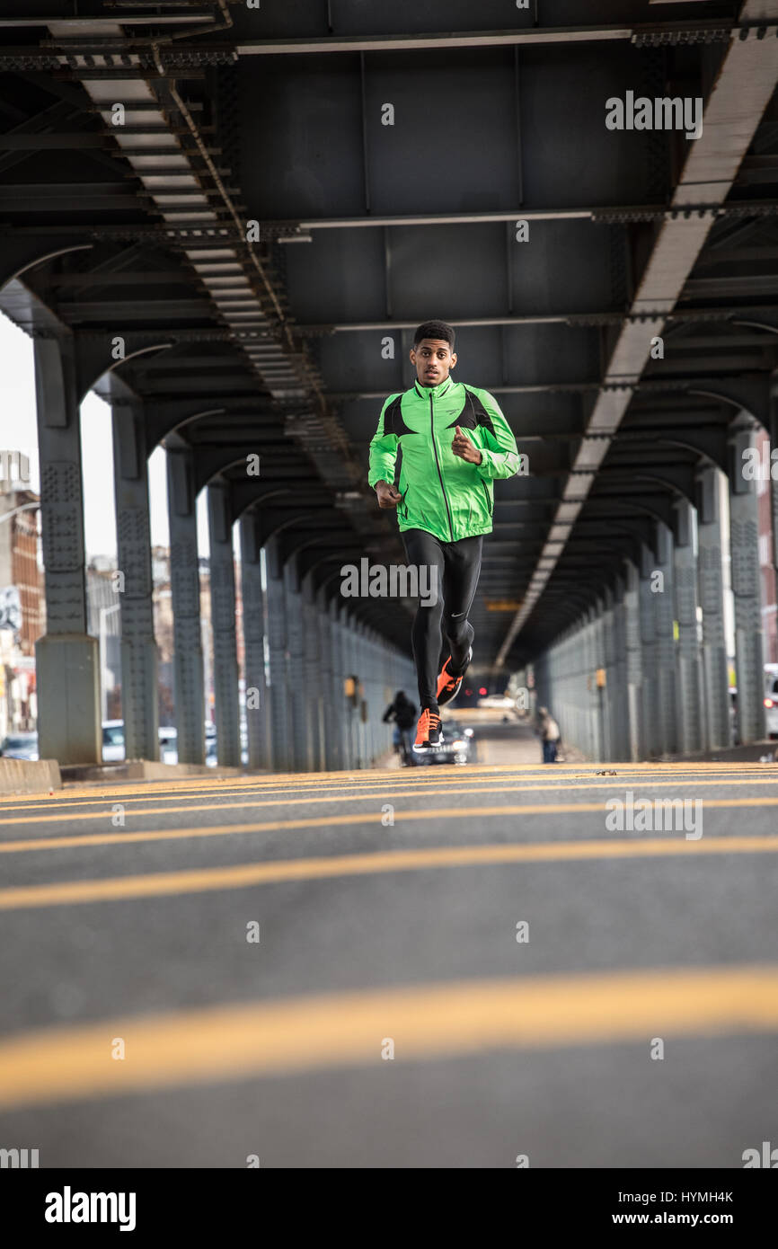 A young, black man goes for a run in the streets of Brooklyn, New York ...