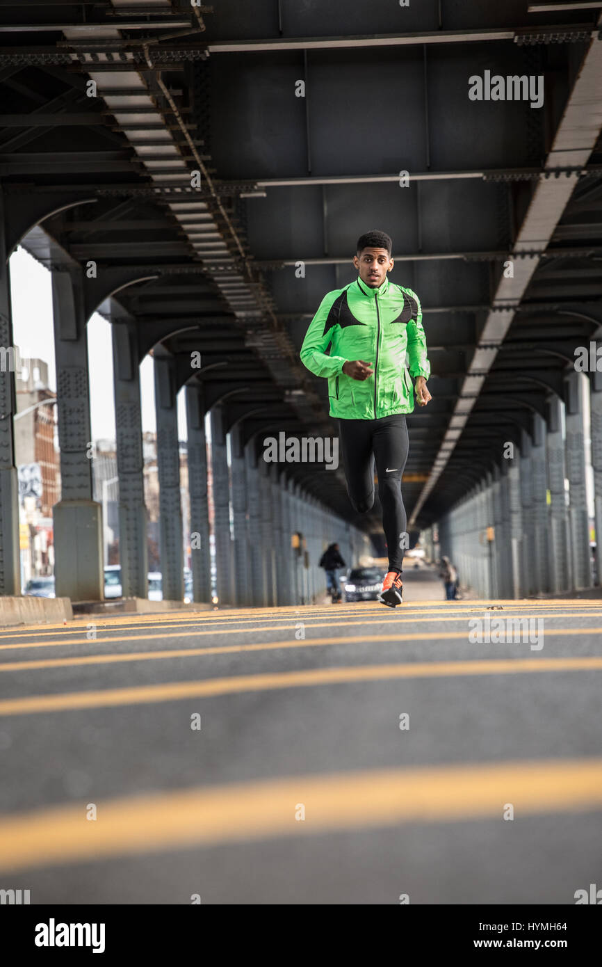 A young, black man goes for a run in the streets of Brooklyn, New York ...