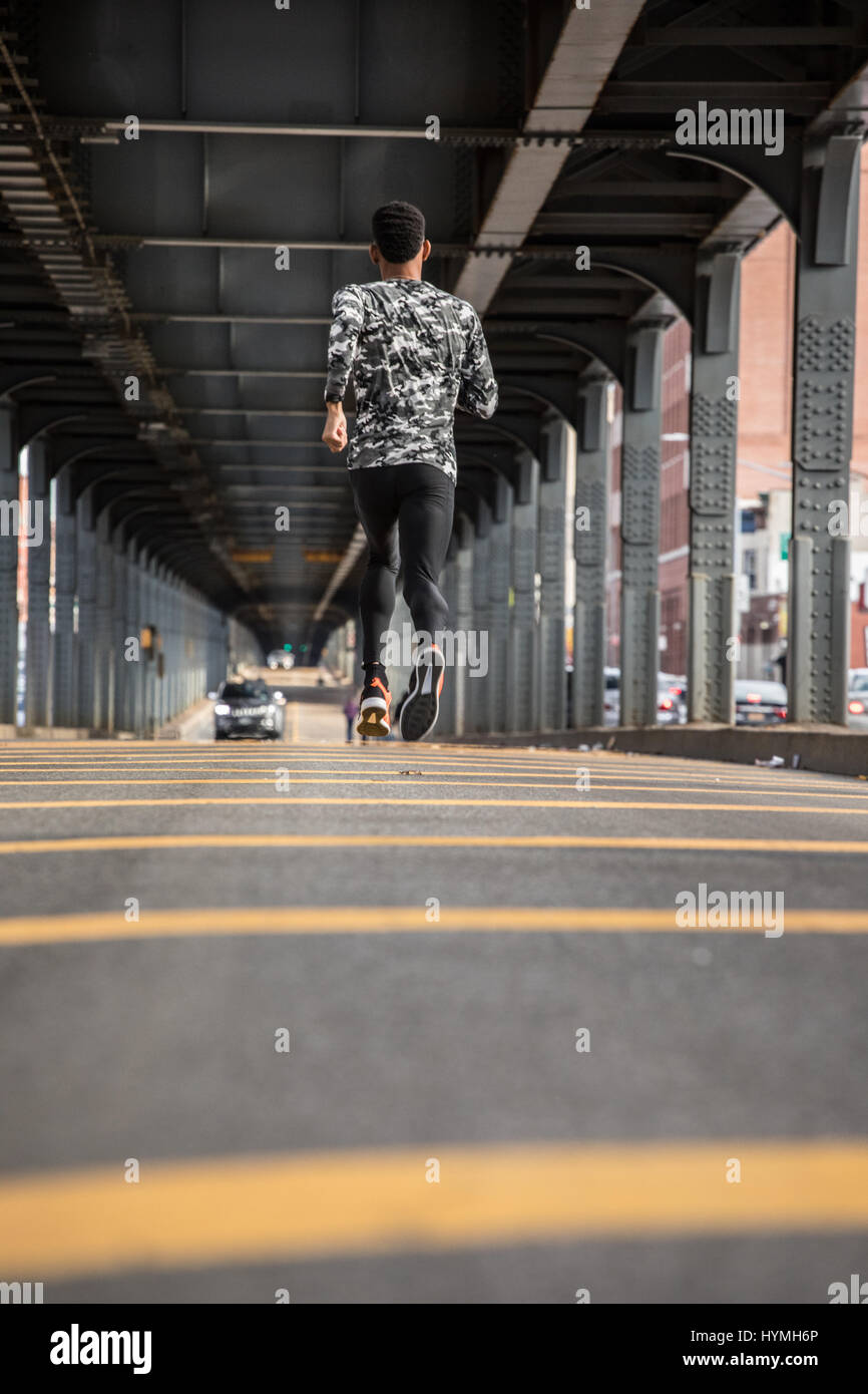 A young, black man goes for a run in the streets of Brooklyn, New York ...
