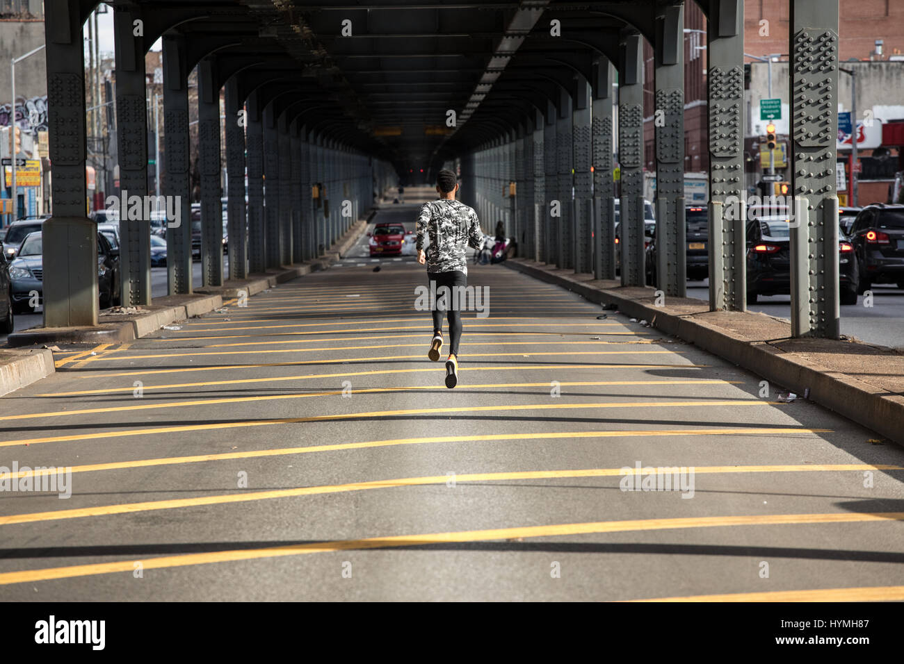 A young, black man goes for a run in the streets of Brooklyn, New York ...