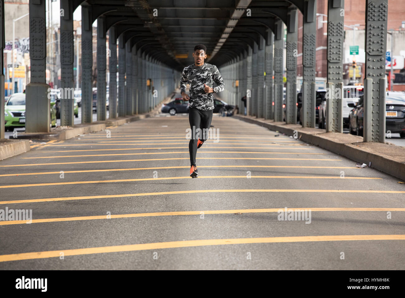 A young, black man goes for a run in the streets of Brooklyn, New York ...