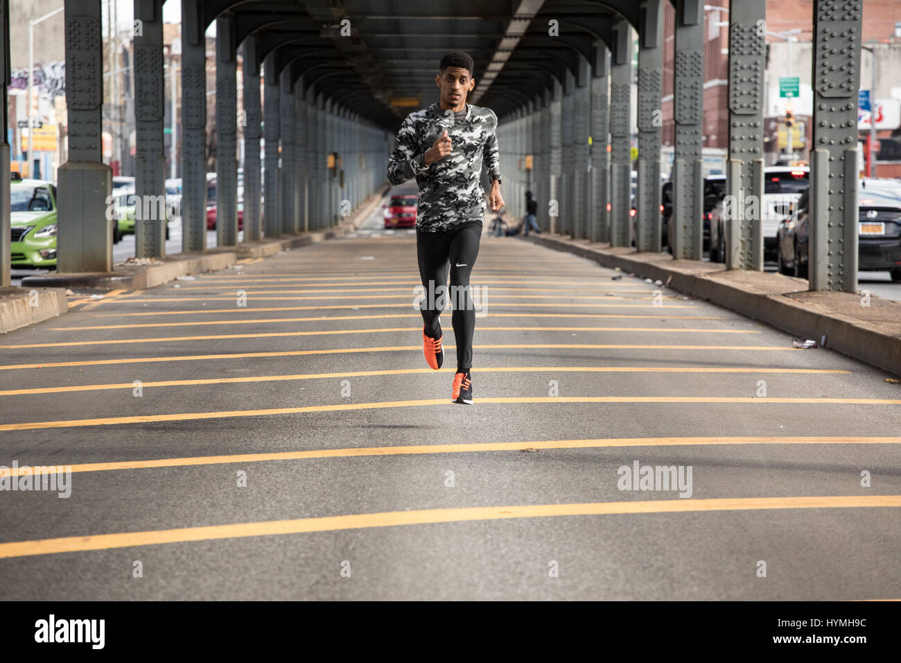 A young, black man goes for a run in the streets of Brooklyn, New York ...