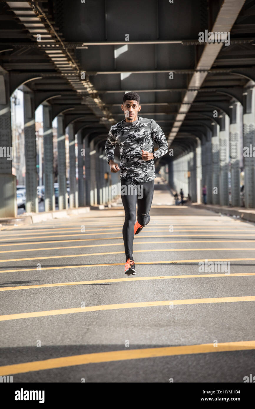 A young, black man goes for a run in the streets of Brooklyn, New York ...