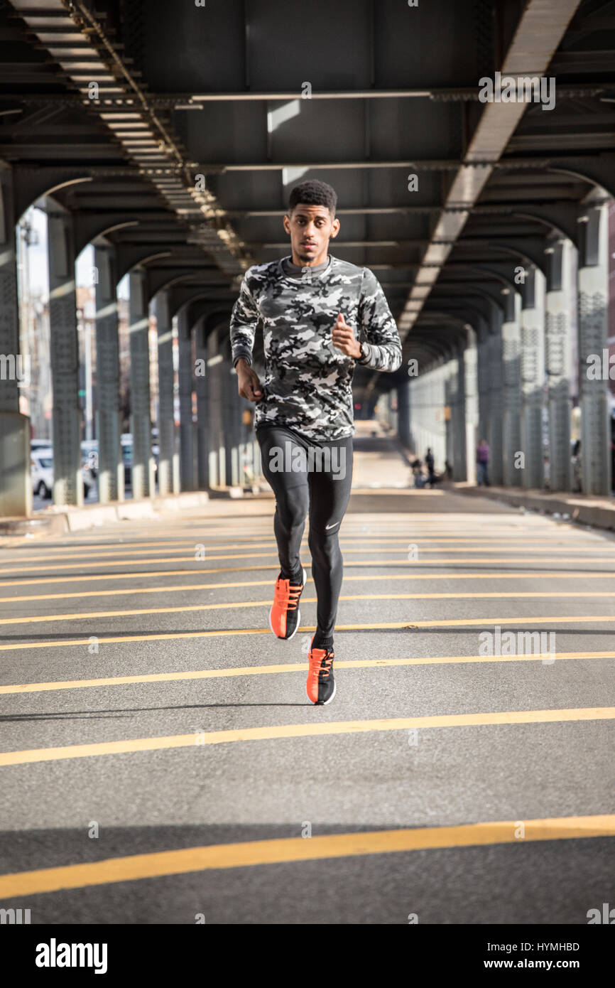 A young, black man goes for a run in the streets of Brooklyn, New York ...