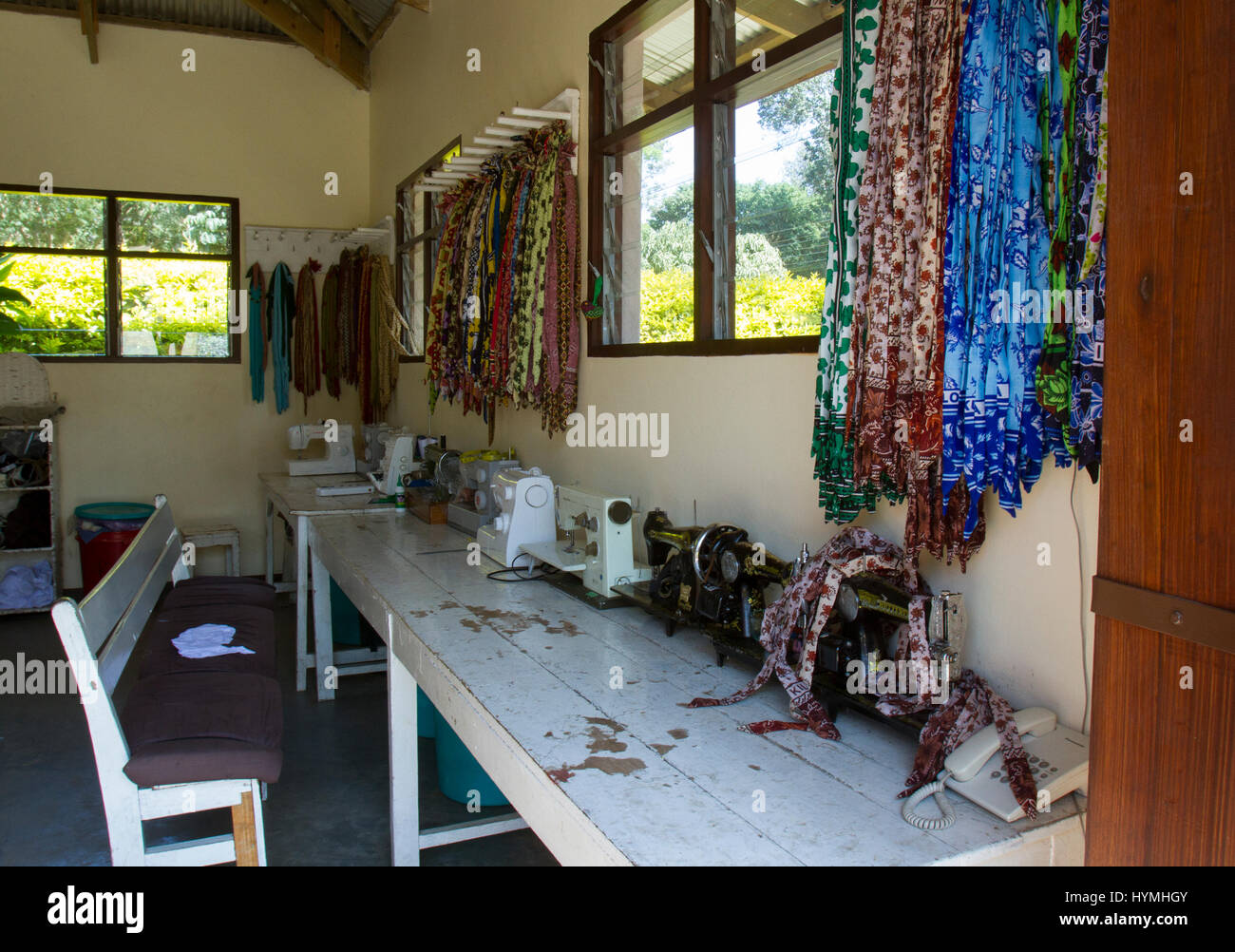 Sewing machines and fabric inside rustic crafts shop in Tanzania ...