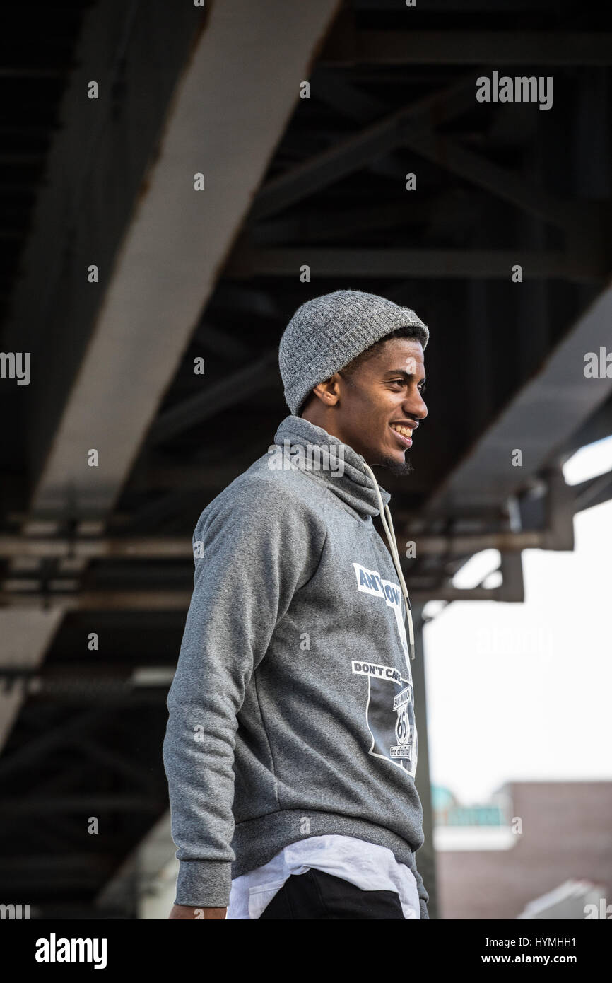 A young, black hipster poses for a candid photograph in NYC. Shot ...