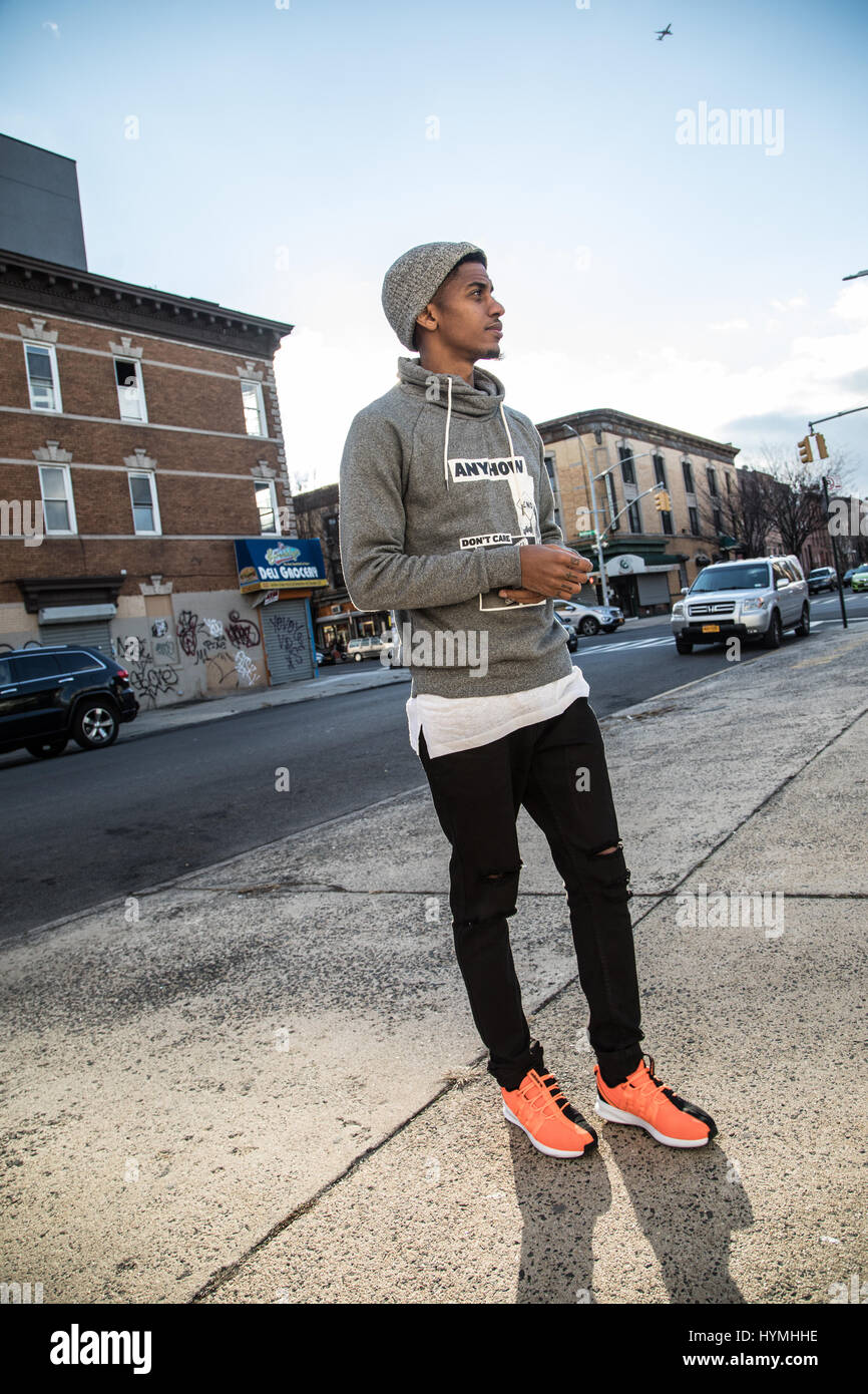 A young, black hipster poses for a candid photograph in NYC. Shot ...
