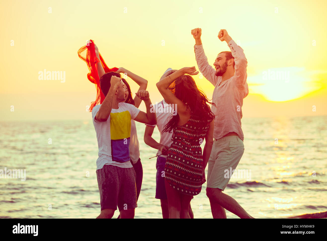 Young People Dancing On Beach at Sunset Stock Photo - Alamy