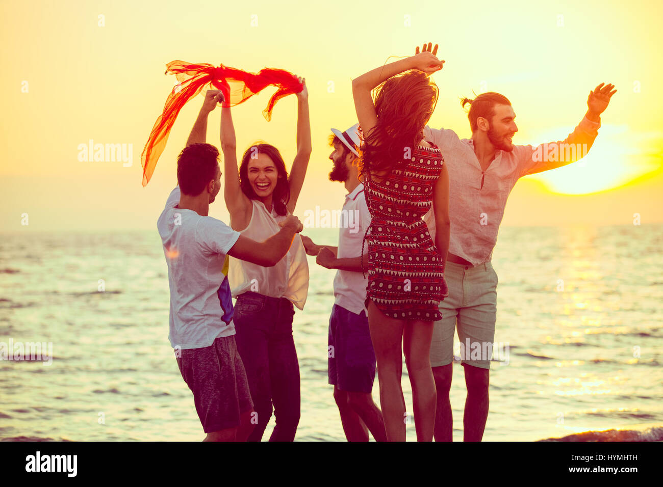 Young People Dancing On Beach at Sunset Stock Photo - Alamy