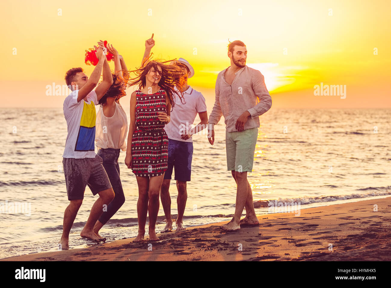 Young People Dancing On Beach at Sunset Stock Photo - Alamy
