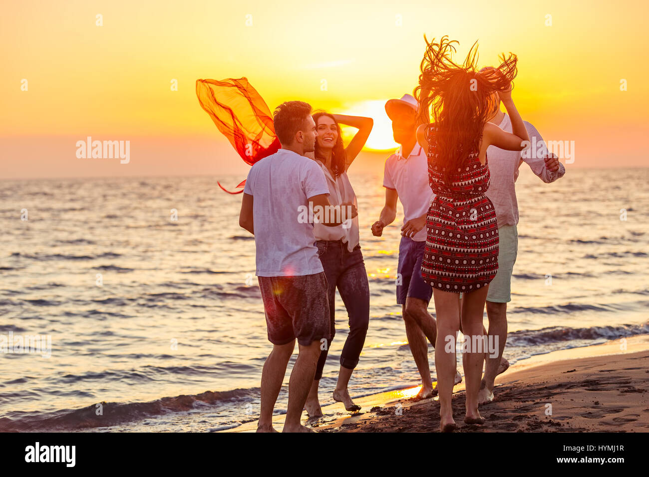 Young People Dancing On Beach at Sunset Stock Photo - Alamy