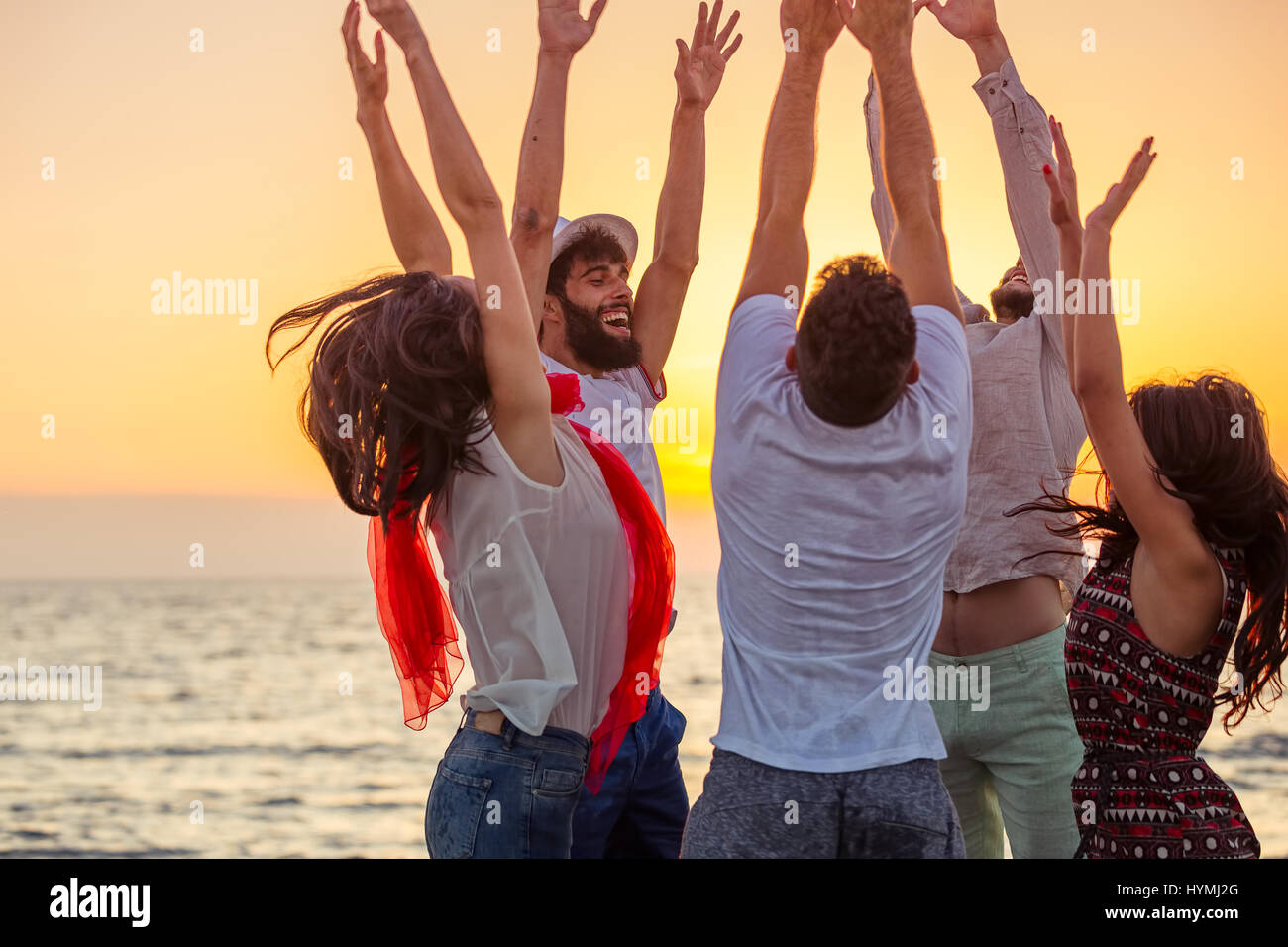 Young People Dancing On Beach at Sunset Stock Photo - Alamy