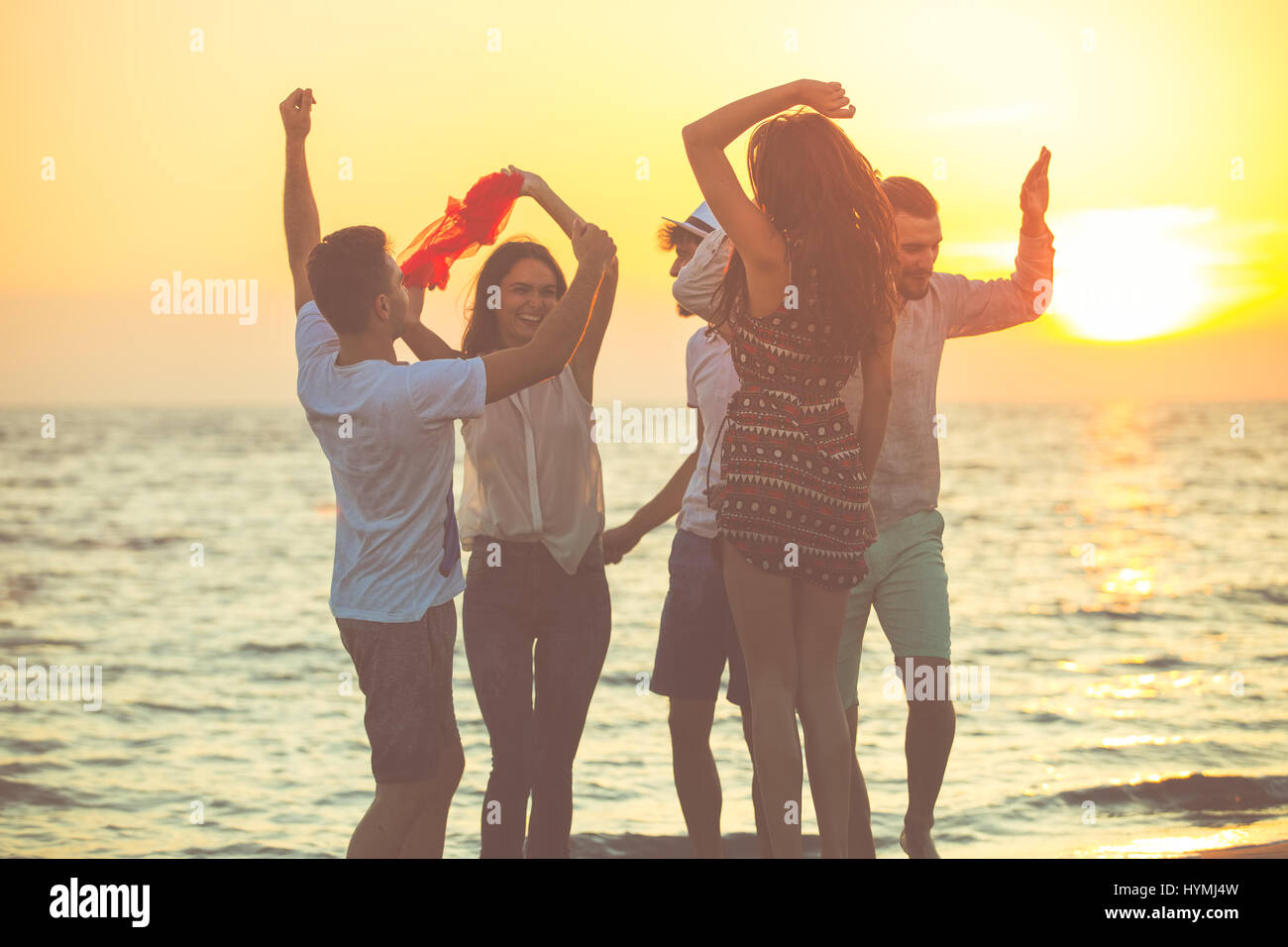 Young People Dancing On Beach at Sunset Stock Photo - Alamy