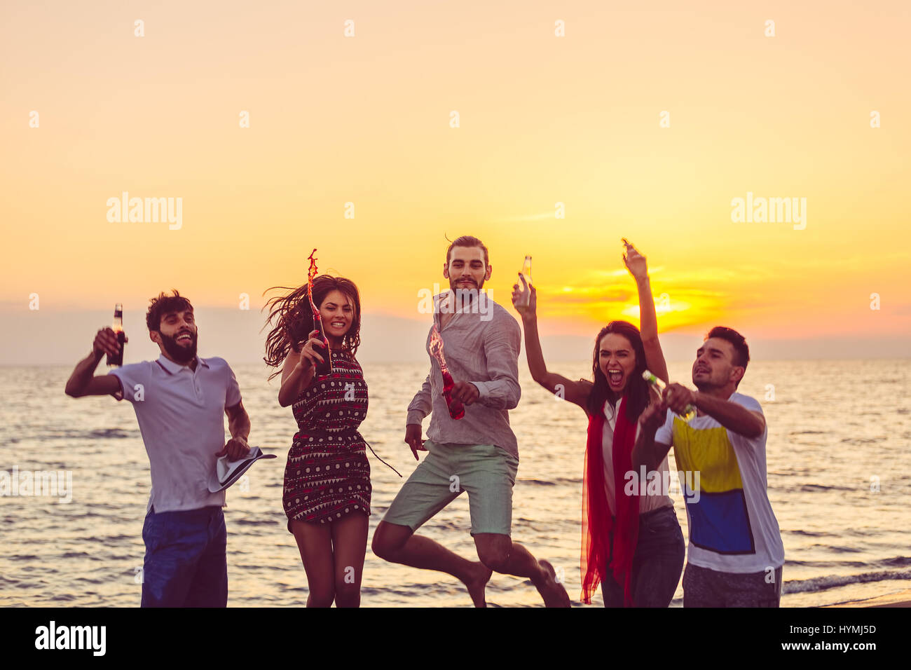 Young People Dancing On Beach at Sunset Stock Photo - Alamy