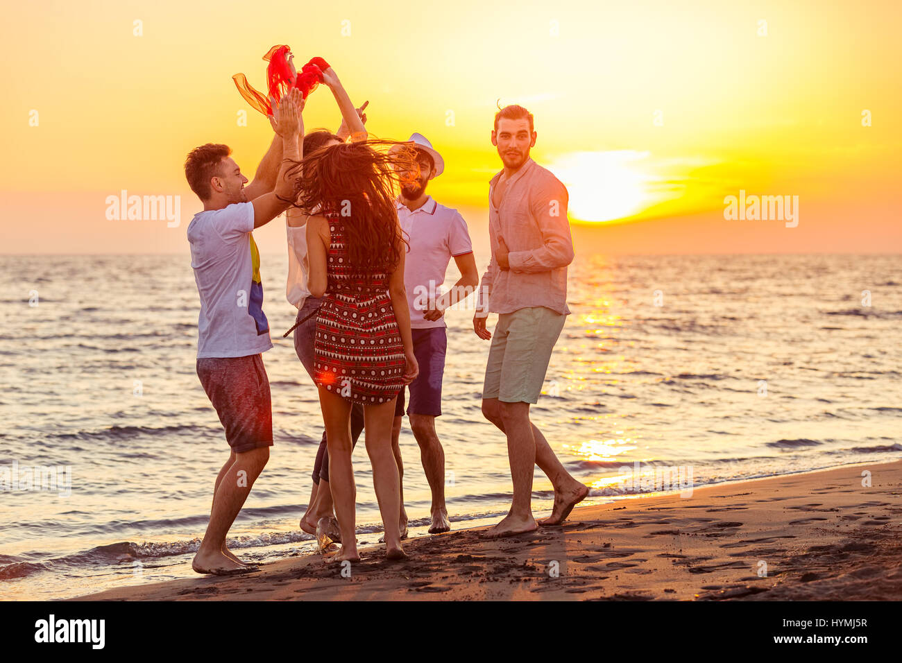 Young People Dancing On Beach at Sunset Stock Photo - Alamy