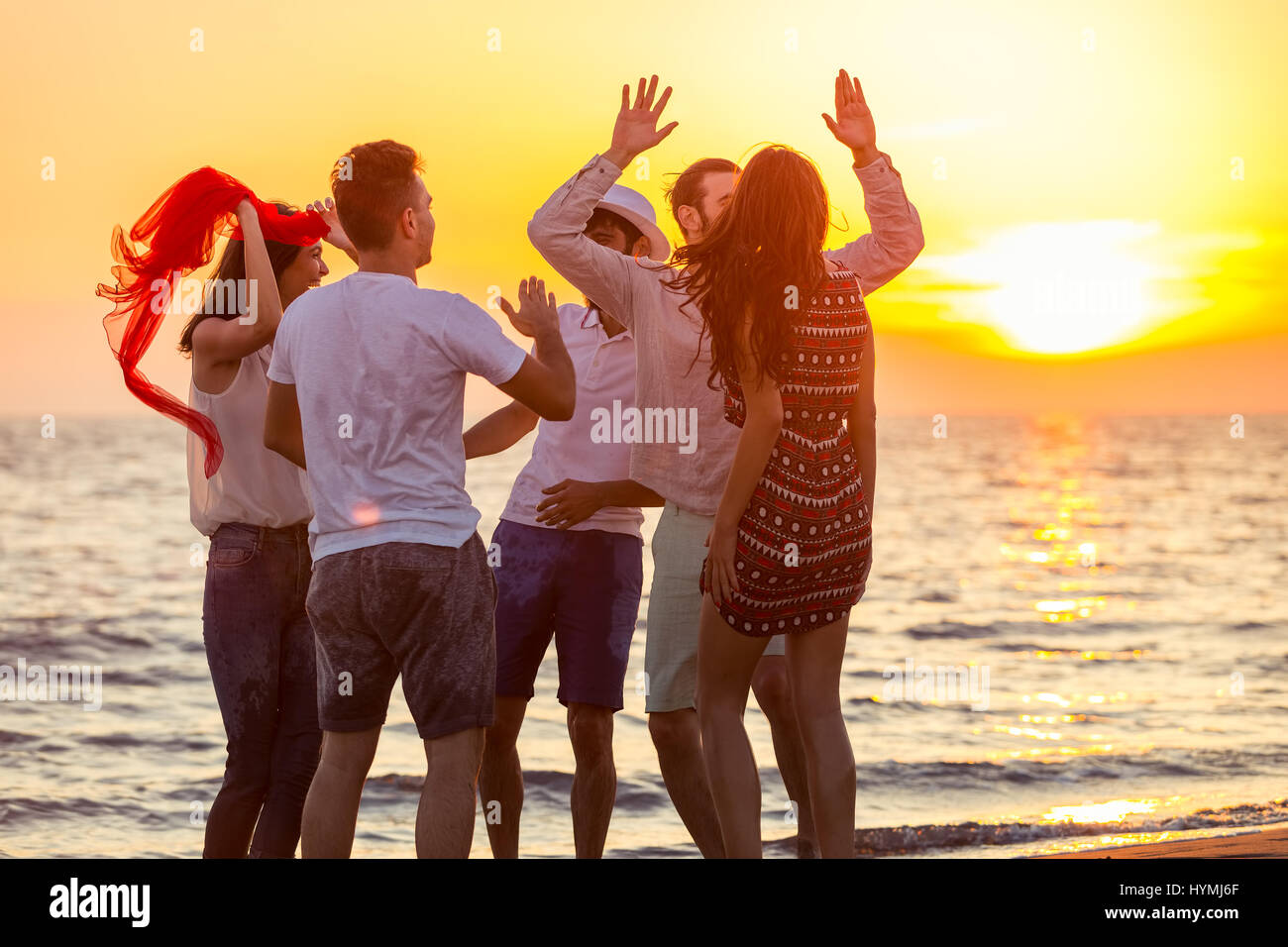 Young People Dancing On Beach at Sunset Stock Photo - Alamy