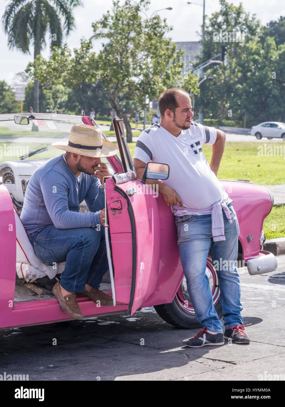 Cuban taxi drivers in their 50's classic pink American car, Old Havana ...