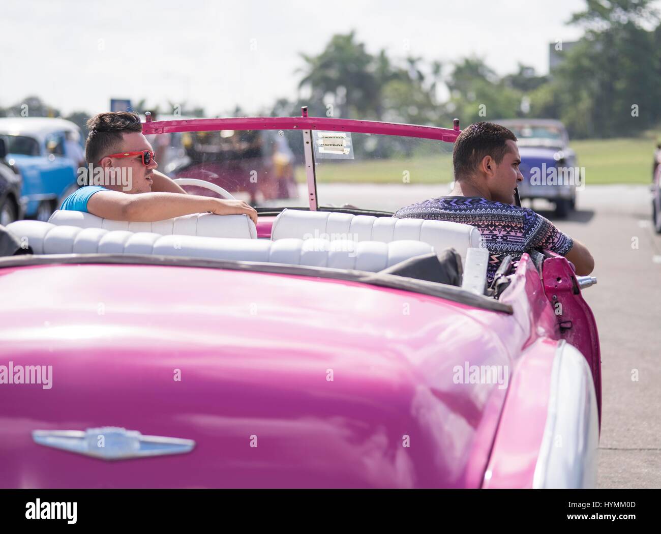 Cuban taxi drivers in their 50's classic pink American car, Old Havana ...