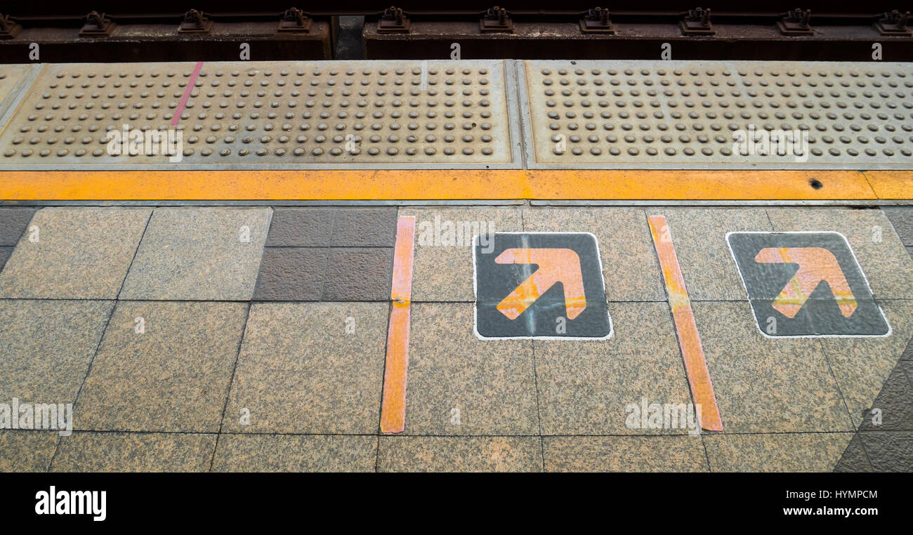Arrow sign on Railway platform at train station Stock Photo - Alamy