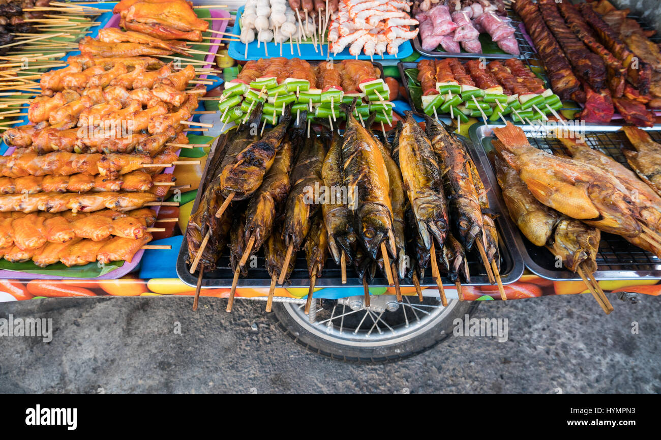 Street food stalls selling seafood, grilled chicken, BBQ, there are ...