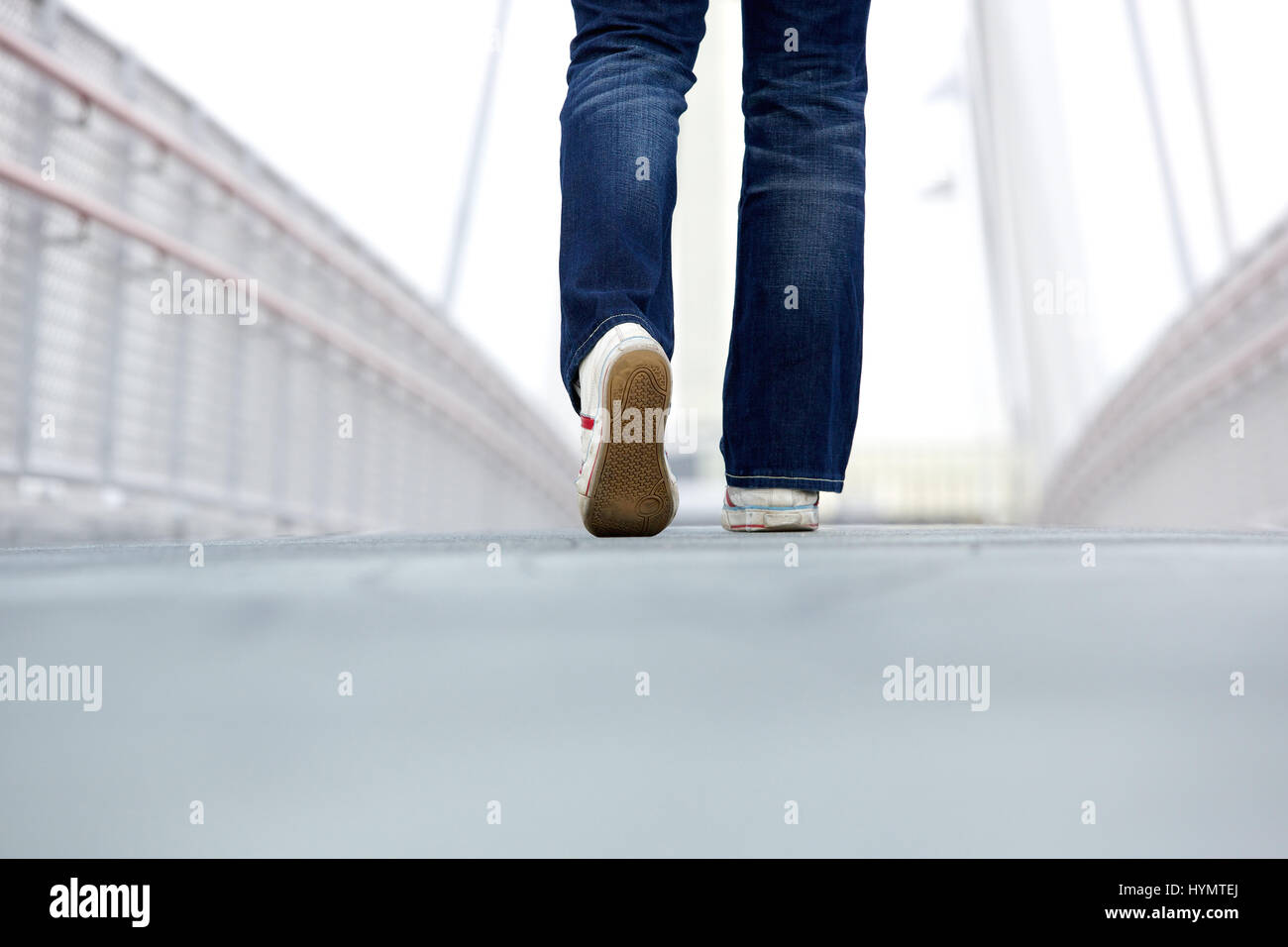 Low angle rear view walking alone outdoors Stock Photo - Alamy
